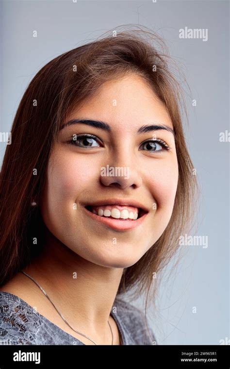 Portrait Captures A Youthful Female With An Engaging Smile Brown Eyes