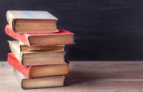 Premium Photo Stack Of Old Vintage Book On A Rustic Wooden Table