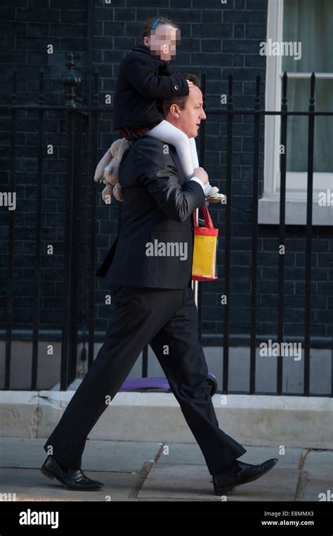 David Cameron Leaves Downing Street Carrying His Daughter Nancy On His