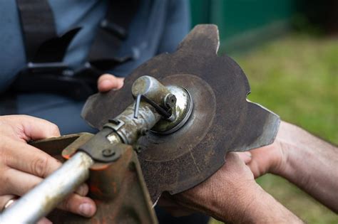 Premium Photo Closeup Of Fixing A Metal Disk For Cutting Grass On A