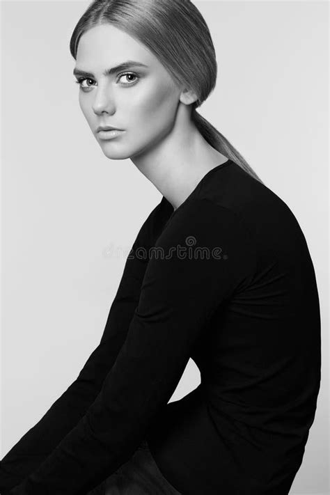 Monochrome Fashion Portrait Of A Beautiful Young Woman Wearing A Black