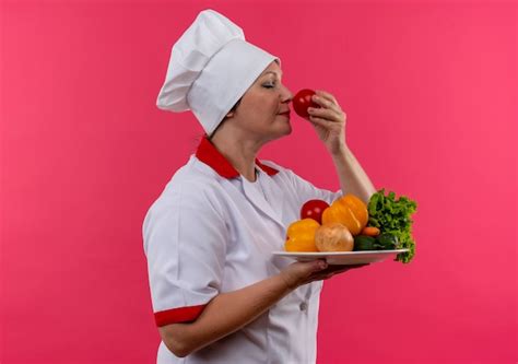 Free Photo Standing Profile View Middle Aged Female Cook In Chef