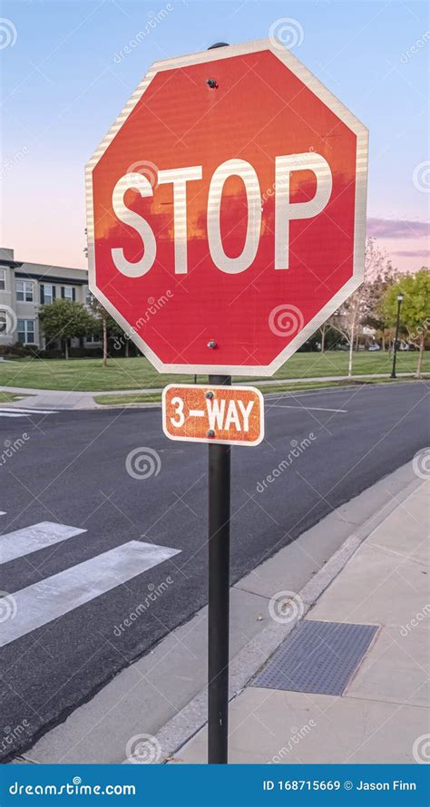 Vertical 3 Way Stop At A Street Intersection At Sunset Stock Image