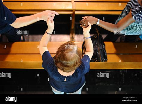 Catholic Mass Faithful Holding Hands While Reciting The Our Father