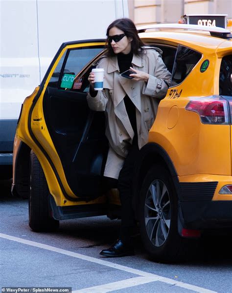 Irina Shayk Covers Up In A Trench Coat As She Takes A Taxi To Her Gym