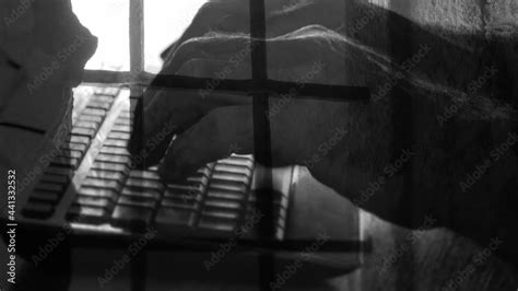 Prison Bars Are Placed On The Hands Of A Programmer Typing A Code On A