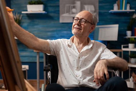 Portrait Of Disabled Artist Using Pencil On Canvas Stock Photo Image