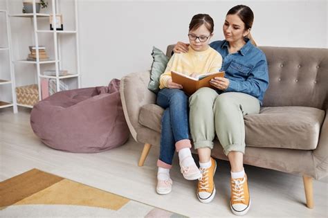 Premium Photo Mom And Daughter Reading Book At Home