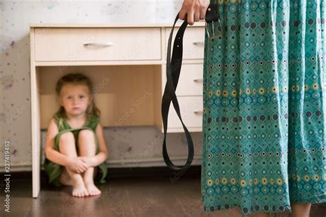 Domestic Violence Mother Holding The Belt In Her Hand To Punish Her