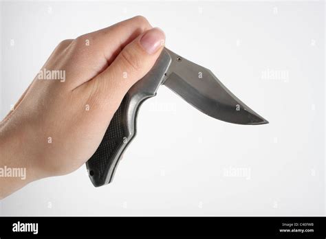 Holding A Lock Knife And Demonstrating Its Use As A Lethal Weapon A