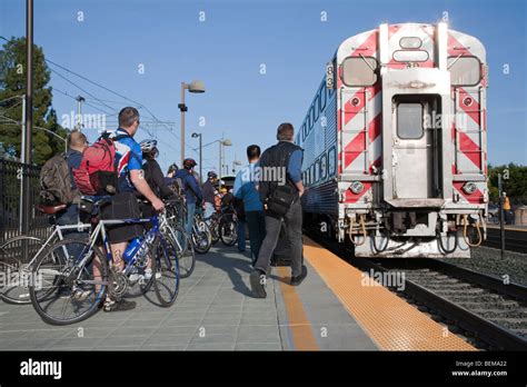 Bicyclists And Commuters Boarding A Caltrain Train At The Downtown