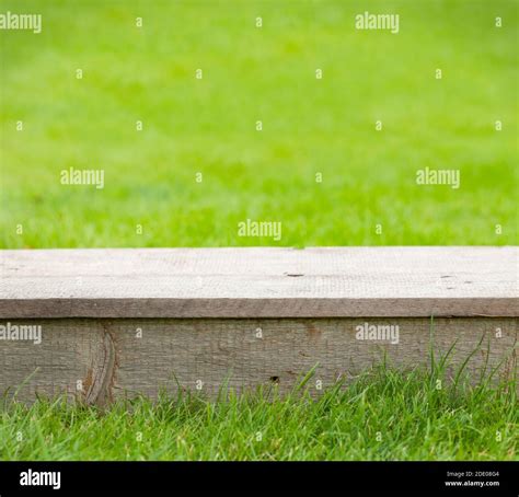 Empty Wooden Table With Outdoor Garden Grass Bokeh Template Backdrop