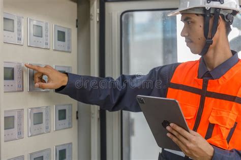 Operational Level Employees Engineer Using Tablet Checks Control System