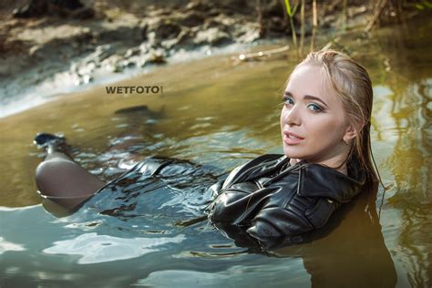 Total Black Wetlook By Blonde In Leather Jacket Skirt Stockings And High Heels