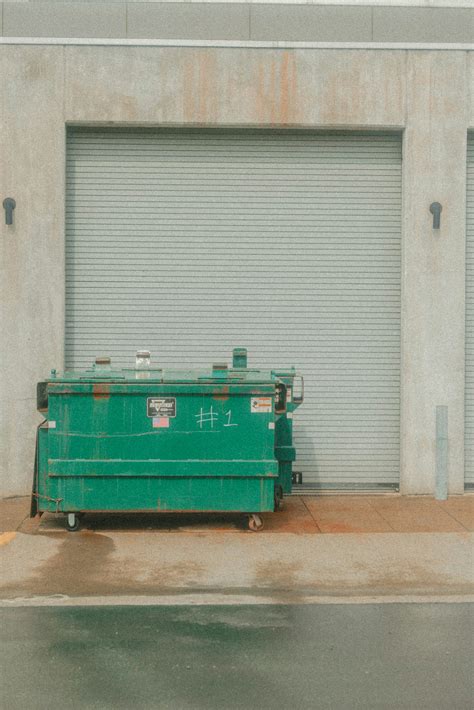 Dumpsters Are Near A Closed Loading Dock Photo Free Street Image On
