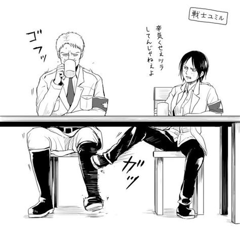 Two People Sitting At A Table In Front Of Each Other With Their Feet On