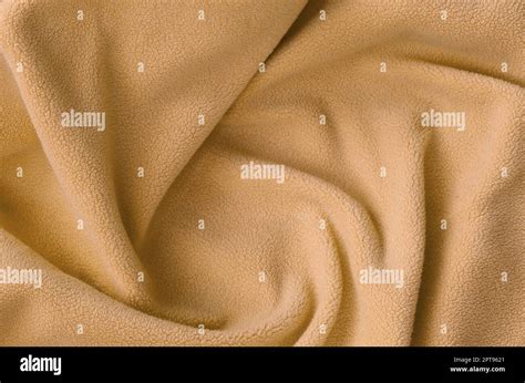 The Blanket Of Furry Orange Fleece Fabric A Background Of Light Orange