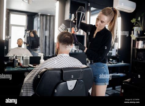 Portrait Of A Man In Barbershop Shave And Cut By Barber Girl Stock