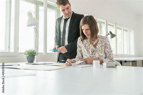 Female And Male Accountant Calculating Costs And Expenses Stock Photo Adobe Stock