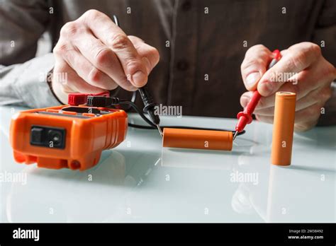 Electrician Measuring Battery Voltage With A Multimeter Home Master