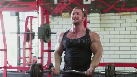 An Attractive Man Bodybuilder Performing Barbell Biceps Curls Stock Video Video Of Muscle