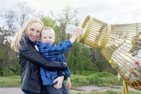 Mother And Son Throw The Plastic Bottle Into The Plastic Collection