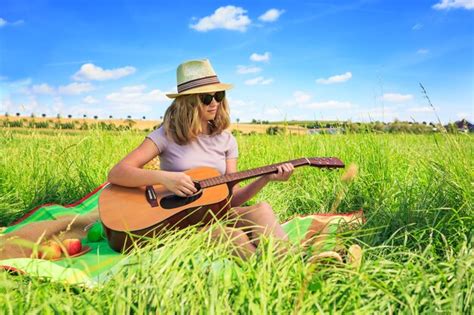 Premium Photo Woman Sitting On Grass In Field