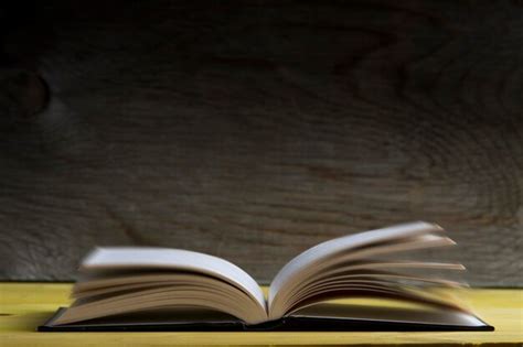 Premium Photo Open Book Kept On Wooden Table