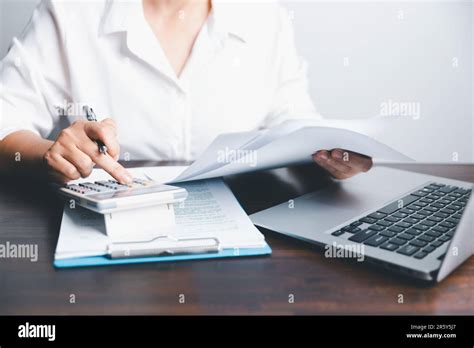 Close Up Woman With Calculator Counting Making Notes At Home Hand Is
