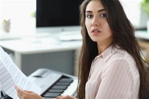 Premium Photo Woman Holds Musical Notes And Plays Home Synthesizer