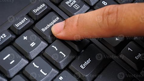 Close Up On Finger Pressing Backspace Button On Keyboard Isolated On