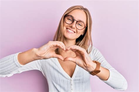 Beautiful Blonde Woman Wearing Casual Clothes And Glasses Smiling In