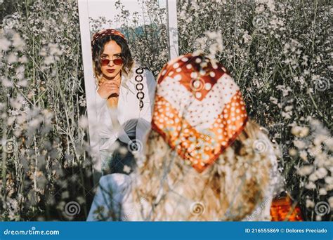 Image Of A Beautiful Woman Looking At Her Reflection In A Mirror In A
