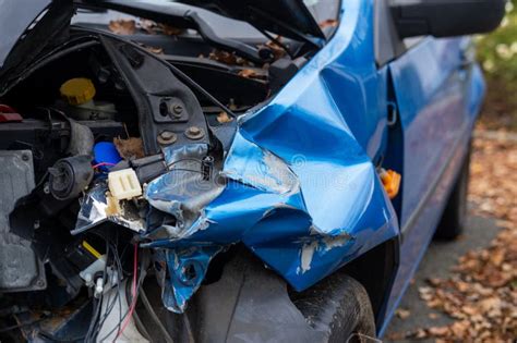 Heavily Damaged Car With Crumpled Hood And Exposed Engine Aftermath
