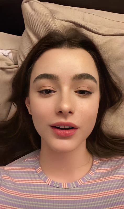 A Woman Laying In Bed With Her Eyes Closed