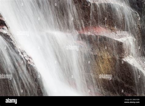 Stunning Close Up Details Of Powerful Waterfall Cascading Down The Red Wet Rocks And Soft