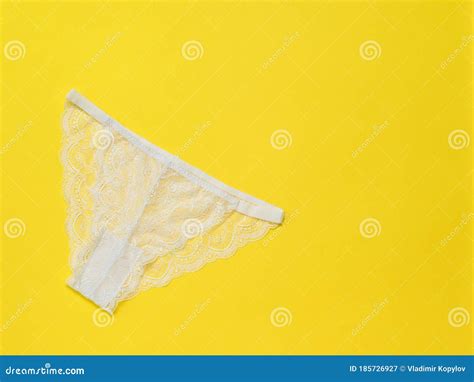 Fashionable Women`s White Panties On A Yellow Background Underwear