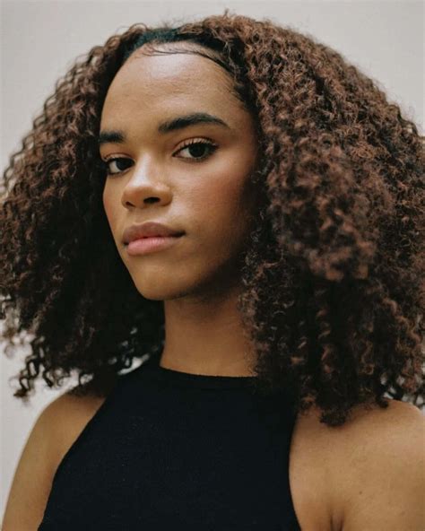 Download Portraitof Young Womanwith Curly Hair Wallpaper