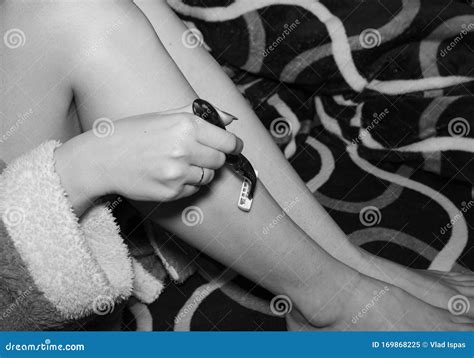 Close Up View Of Woman Shaving Legs In Bed At Home Shaving Legs And Skin Care Girl With A