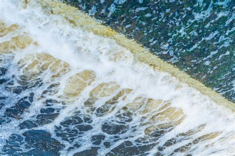 Rapid Flow Of A River A Stream Of Falling Blue Water Forms A Lot Of