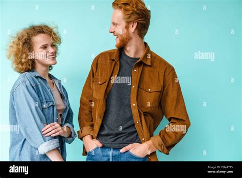 Young Cheerful Redhead Couple Smiling While Talking Each Other Isolated