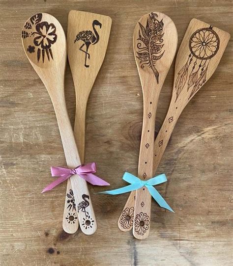 Three Wooden Spoons With Designs On Them