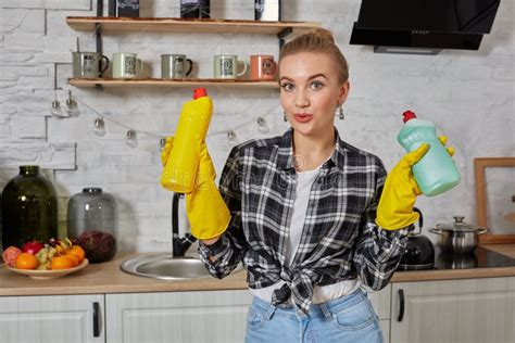 Woman Comparing Detergent Products She Is Holding Two Bottles And