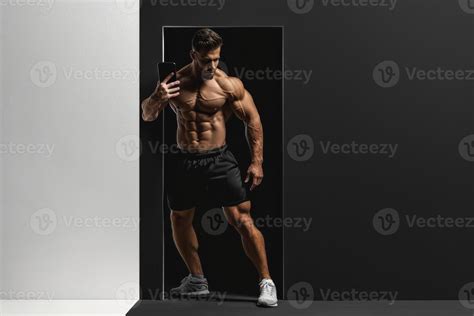 AI Generated Sexy Muscular Man In Shorts And Bare Chested Uses A Smartphone Filming Himself