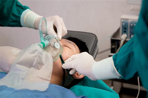 병원 수술실에서 환자 응급 처치와 산소 마스크를 들고 의사와 조수의 클로즈업 손 외과 의사 치유 및 수술 호흡 문제 의료 및
