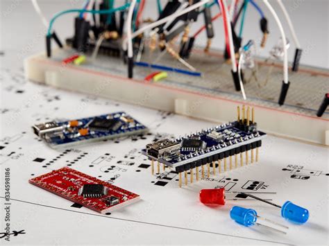 Arduino And Programmers With Peripherals And Expansion Boards Lie On A