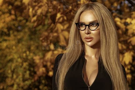 Pretty Blonde Woman With Glasses At Outdoors With Happy Expression