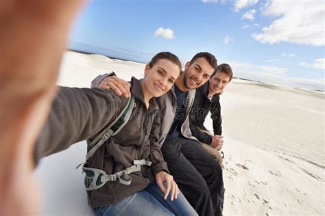 Taking A Roadtrip Selfie A Group Of Friends Sitting On Their Car While