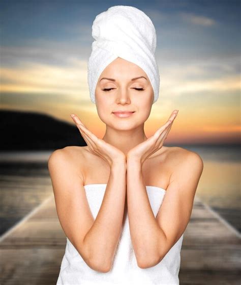 Premium Photo Young Lovely Lady Applying Moisturizer To Her Face