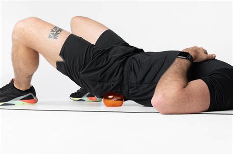 Man Using Ball To Massage Glute Muscles